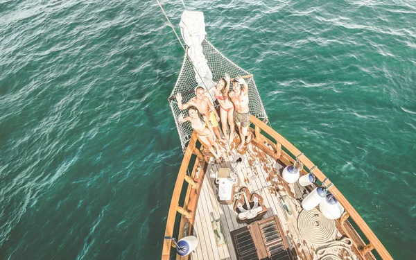 Happy rich multicultural friends having fun at sail boat trip ...