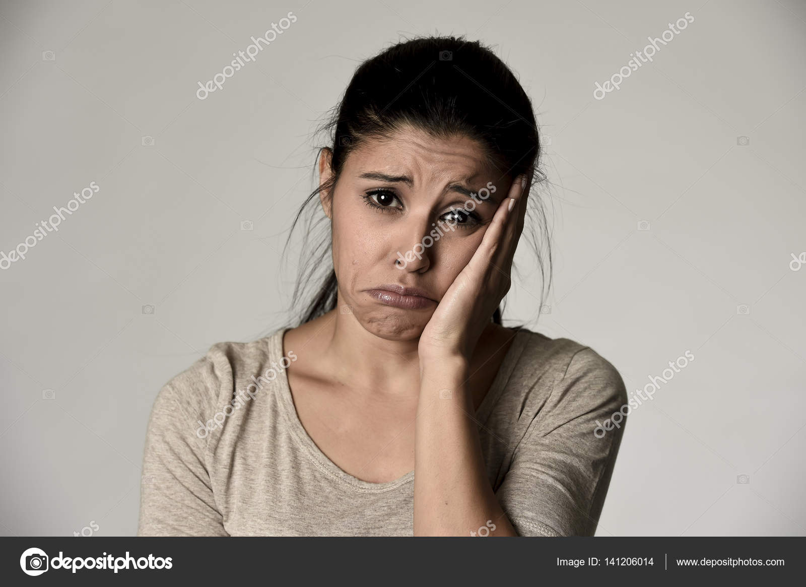 Young beautiful hispanic sad woman serious and concerned in worried ...