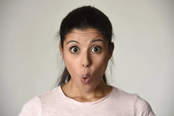 Young beautiful Spanish surprised woman amazed in shock and surprise covering mouth Stock Photo ...