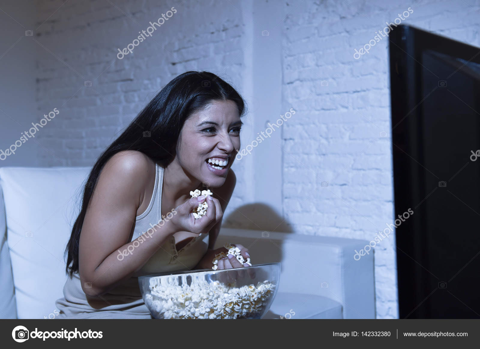 Latin woman home watching television close distance excited in TV ...