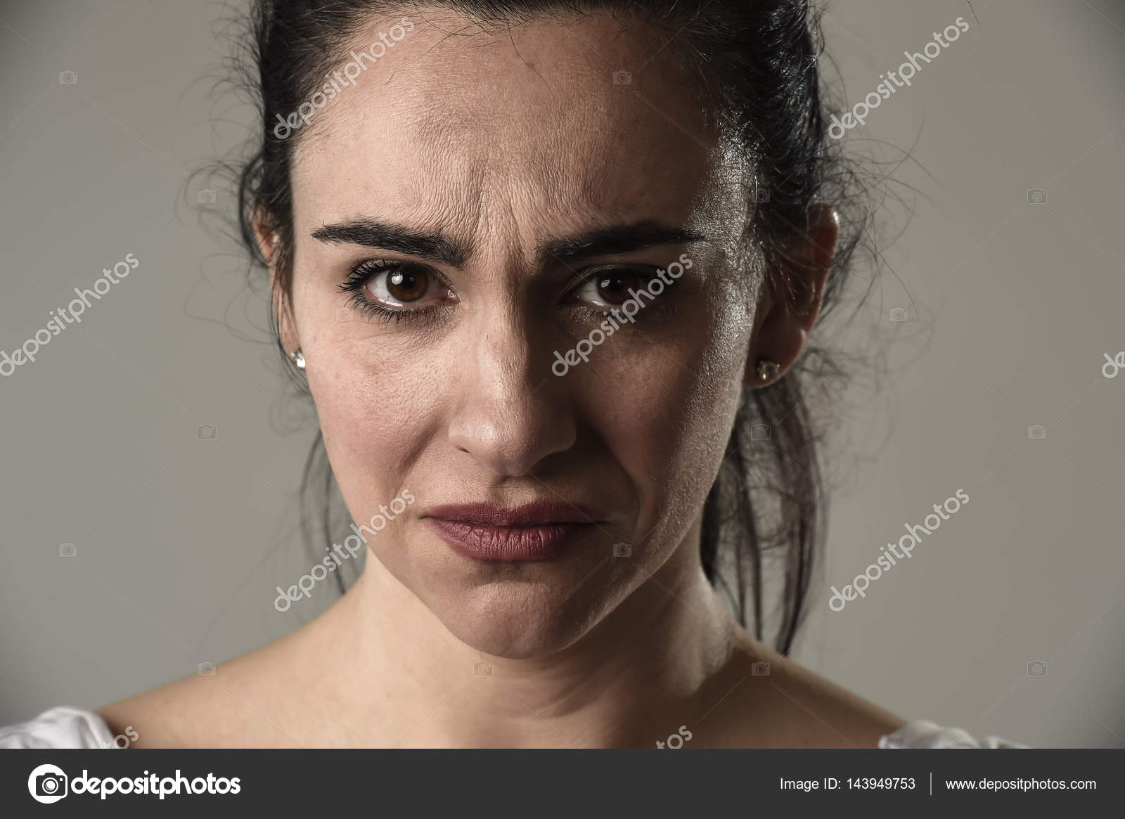 Beautiful and sad woman crying desperate and depressed with tears on her eyes suffering pain ...