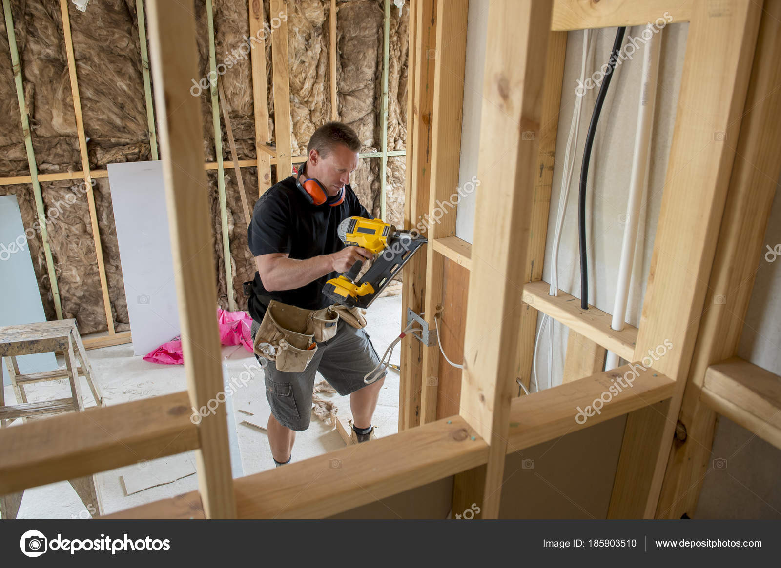 Attractive and confident constructor carpenter or builder man working ...