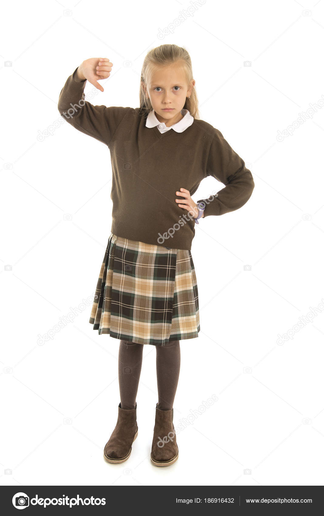 7 or 8 years old sad and frustrated schoolgirl female child in uniform ...
