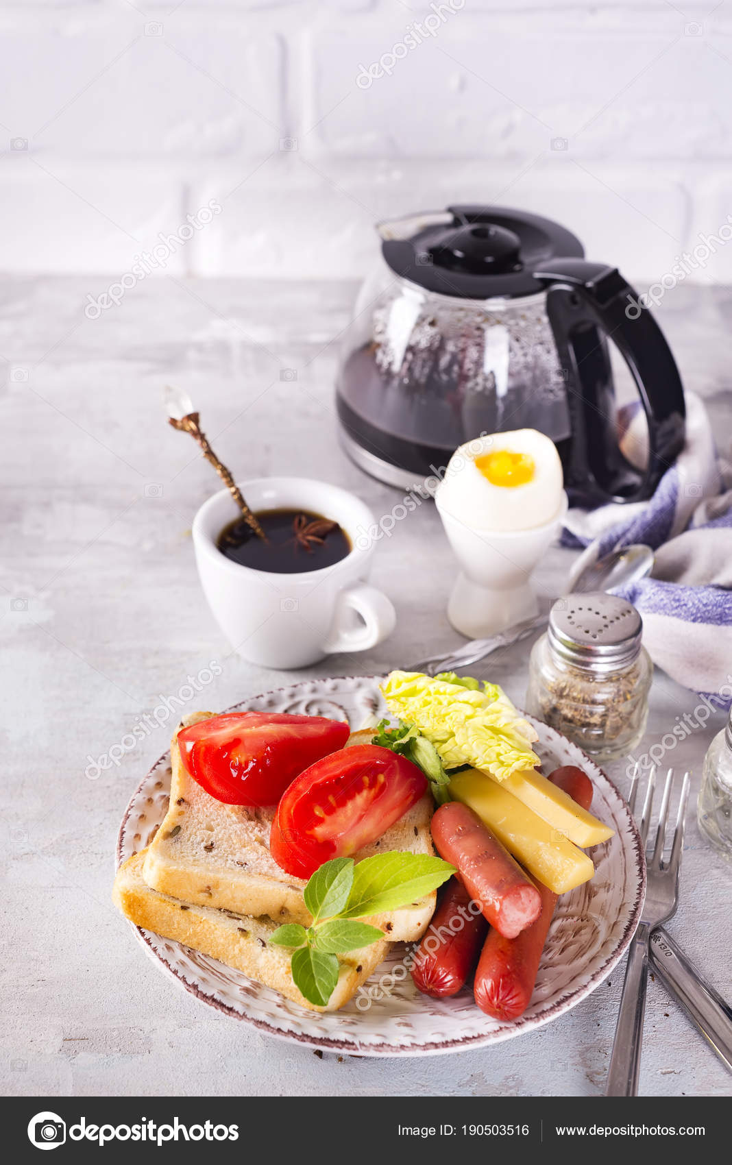 English breakfast. Fried eggs, sausages, toasts, tomatoes on stone ...
