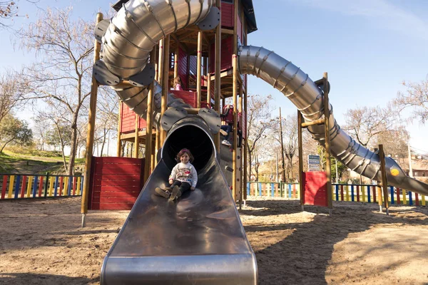Playing on the park slide - Stock Image - Everypixel