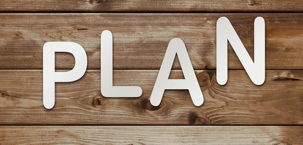 Palabra PLAN de letras blancas sobre fondo de madera de paja antigua ...