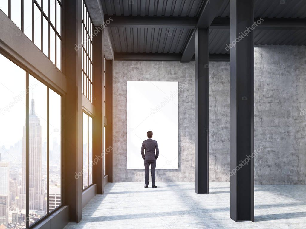 Man looking at large poster in former factory building Stock Photo by ...
