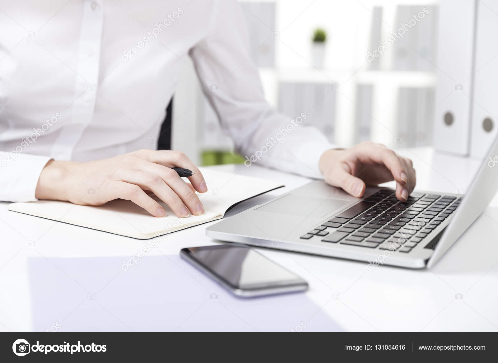 Woman with purple paper typing Stock Photo by ©denisismagilov 131054616