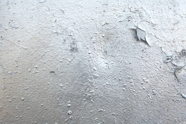 The texture of the old painted wall is covered with cracks and ...