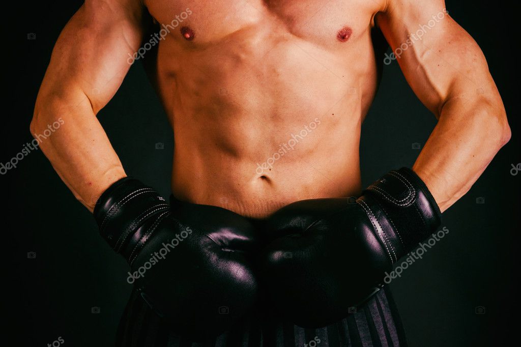 Bodybuilder in boxing gloves on black — Stock Photo © aallm #128495422