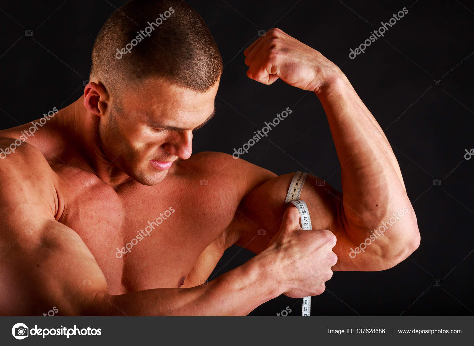 Strong bodybuilder on a black background Stock Photo by ©aallm 137628686