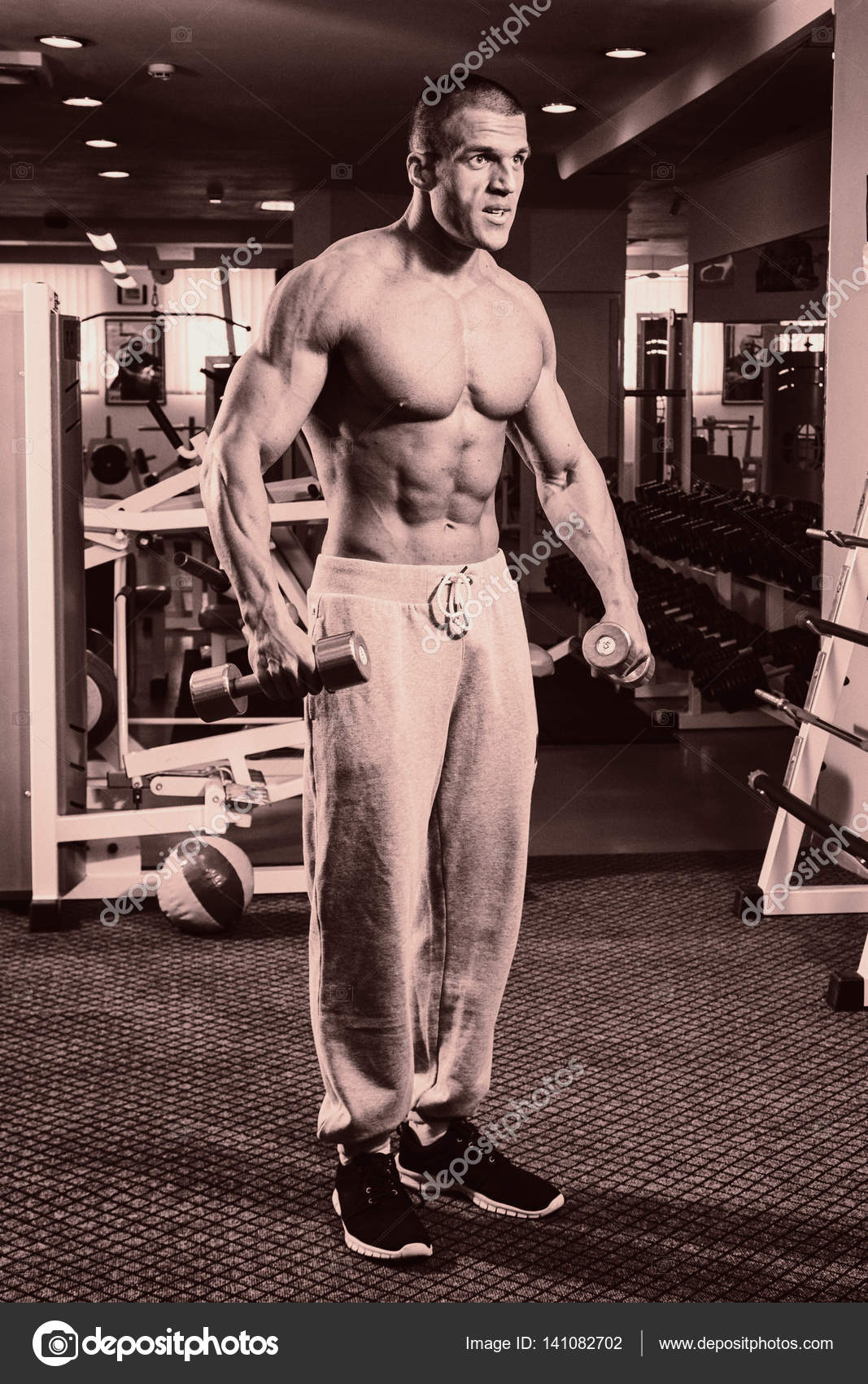 Bodybuilder showing his back and biceps muscles, personal fitnes ...