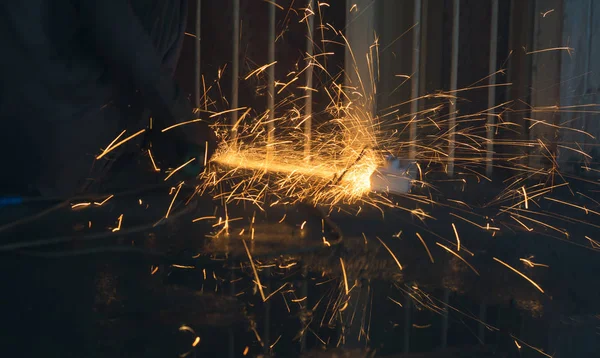 close up of sparks made by angle grinder in a workshop with black ...