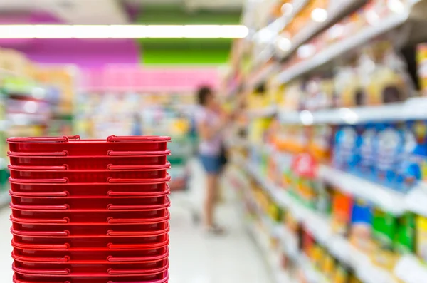 store with trolley and red color baskets - Stock Image - Everypixel