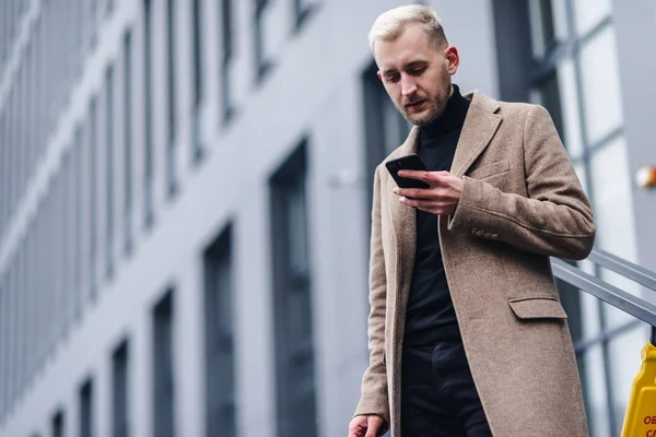 Businessman texting messages while walking. - Stock Image - Everypixel