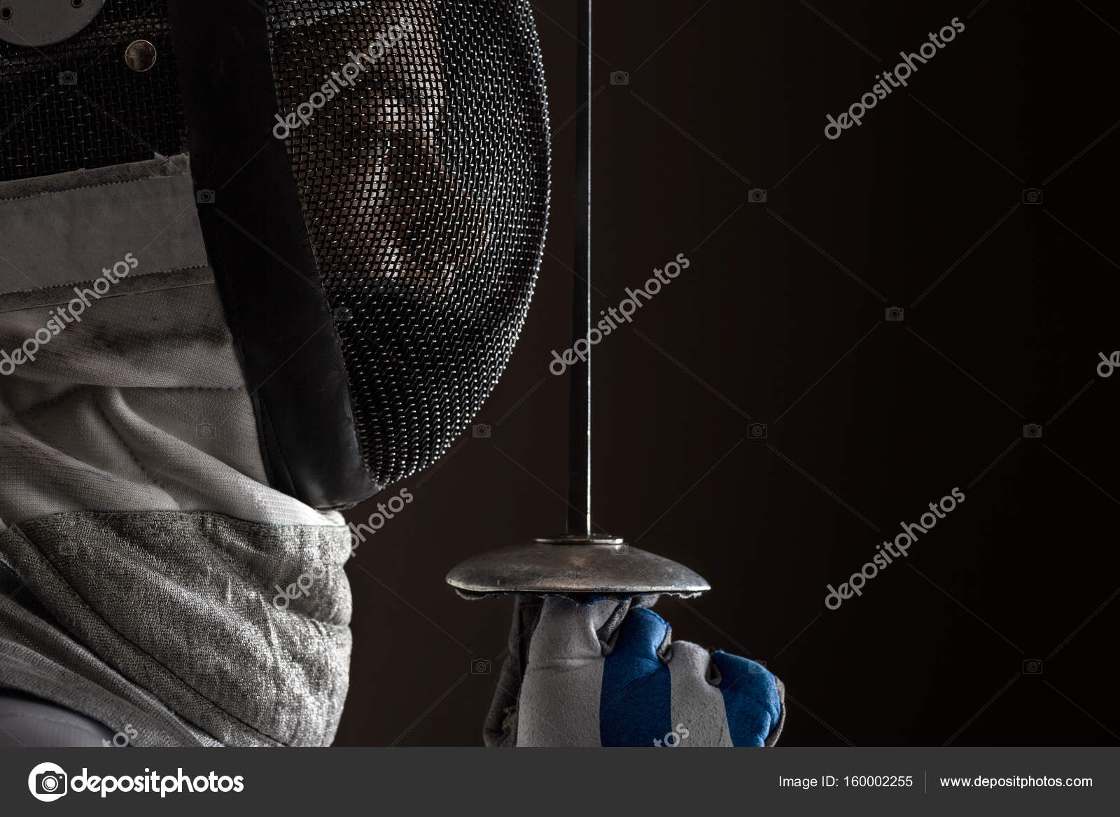 Woman fencer with Mask holding the sword in front of her Stock Photo by ©alessandroguerr 160002255