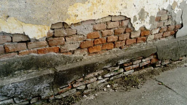 Plaster peeling off brick wall. Old Worn Down Brick Wall With Plaster ...