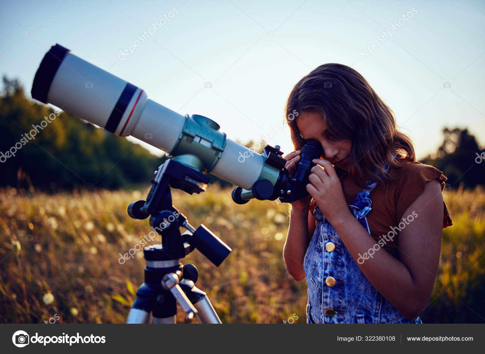 Little girl using telescope in nature to explore the universe. Stock ...