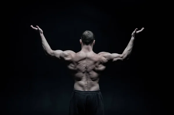 Back view of black bodybuilder raising his hands up Stock Photo by ...