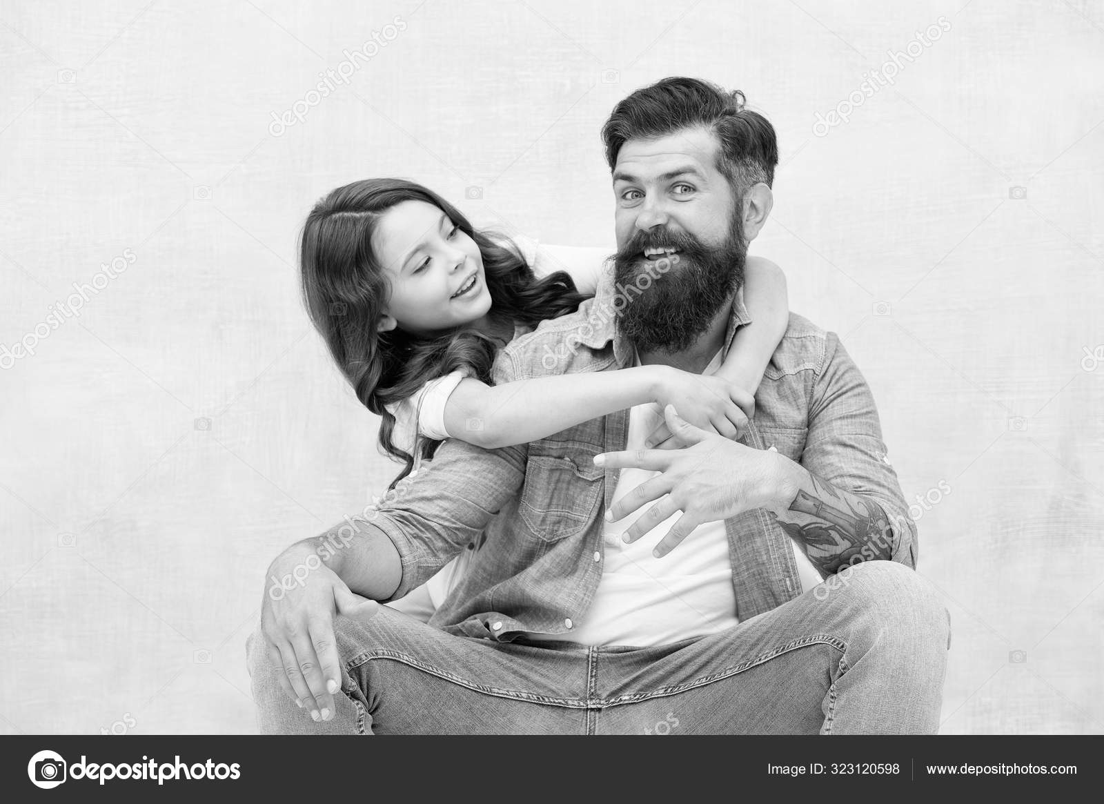 Honoring fathers and celebrating fatherhood. Little daughter hugging father on fathers day ...