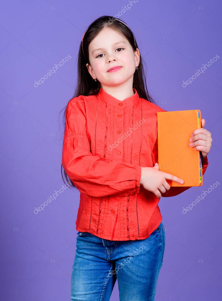 Chica mantenga libro violeta de fondo. Muestra el libro de niños ... Chica mantenga libro violeta de fondo. Muestra el libro de niños ...