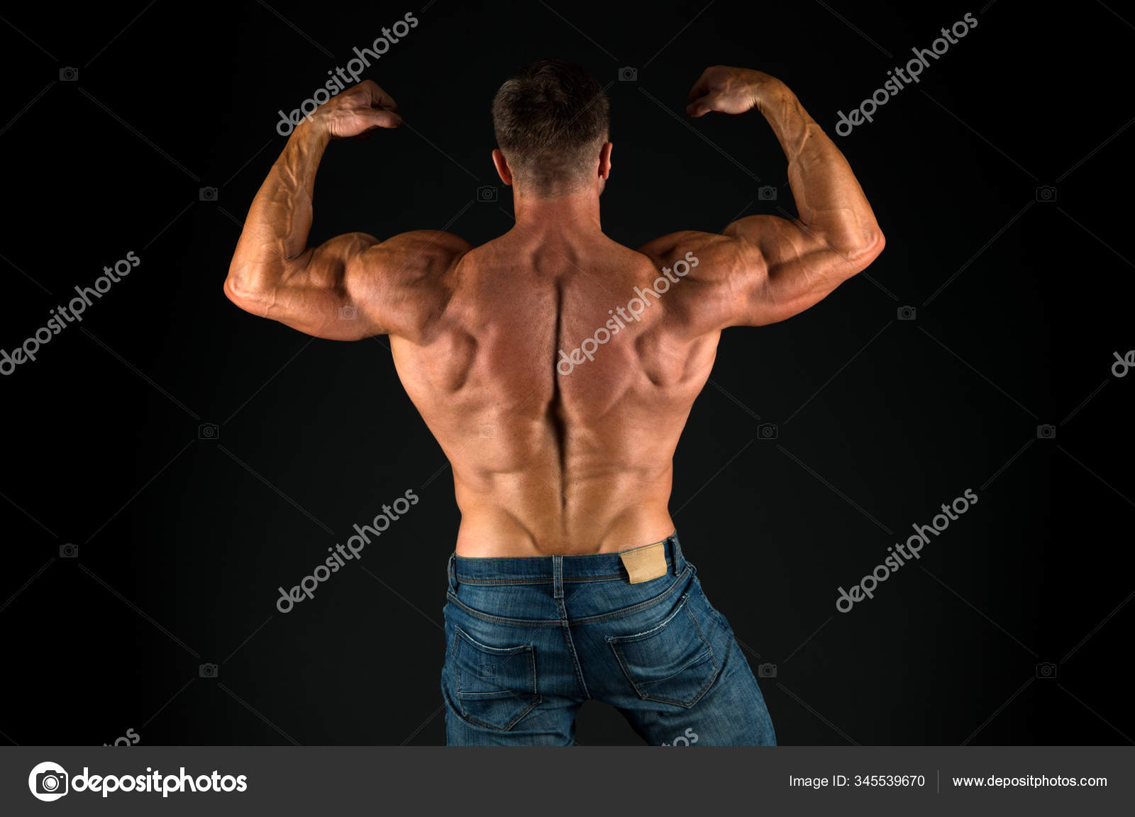 Bodybuilder perfect shape rear view. Strong bodybuilder flexing arms ...