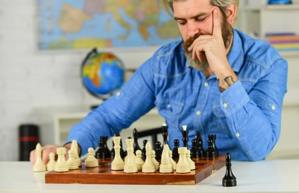 Figures on wooden chess board. Thinking about next step. Chess is ...