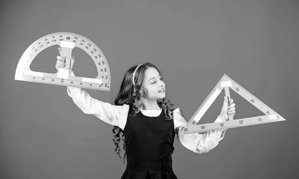 Kid school uniform hold ruler. Pupil cute girl with big ruler. Geometry ...