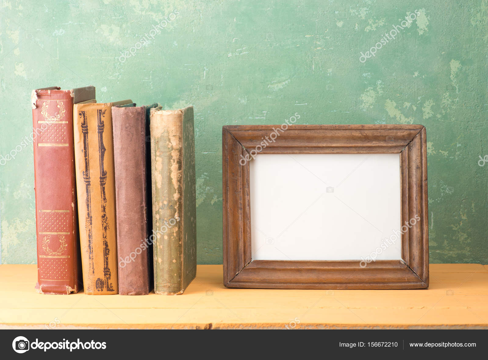 Books and empty picture frame — Stock Photo © olegkrugllyak #156672210