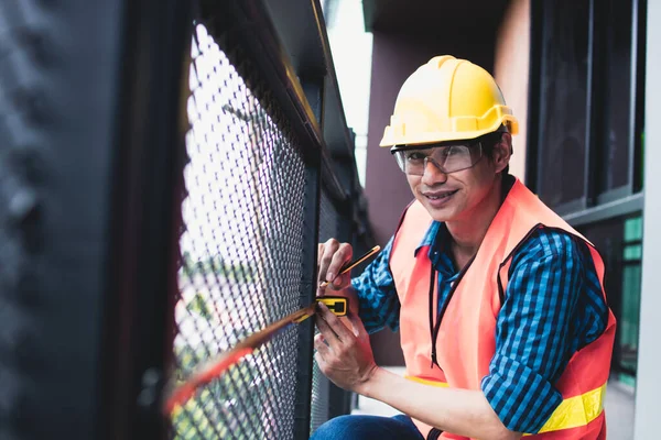 inspector checking and measuring tape measure in building - Stock Image ...