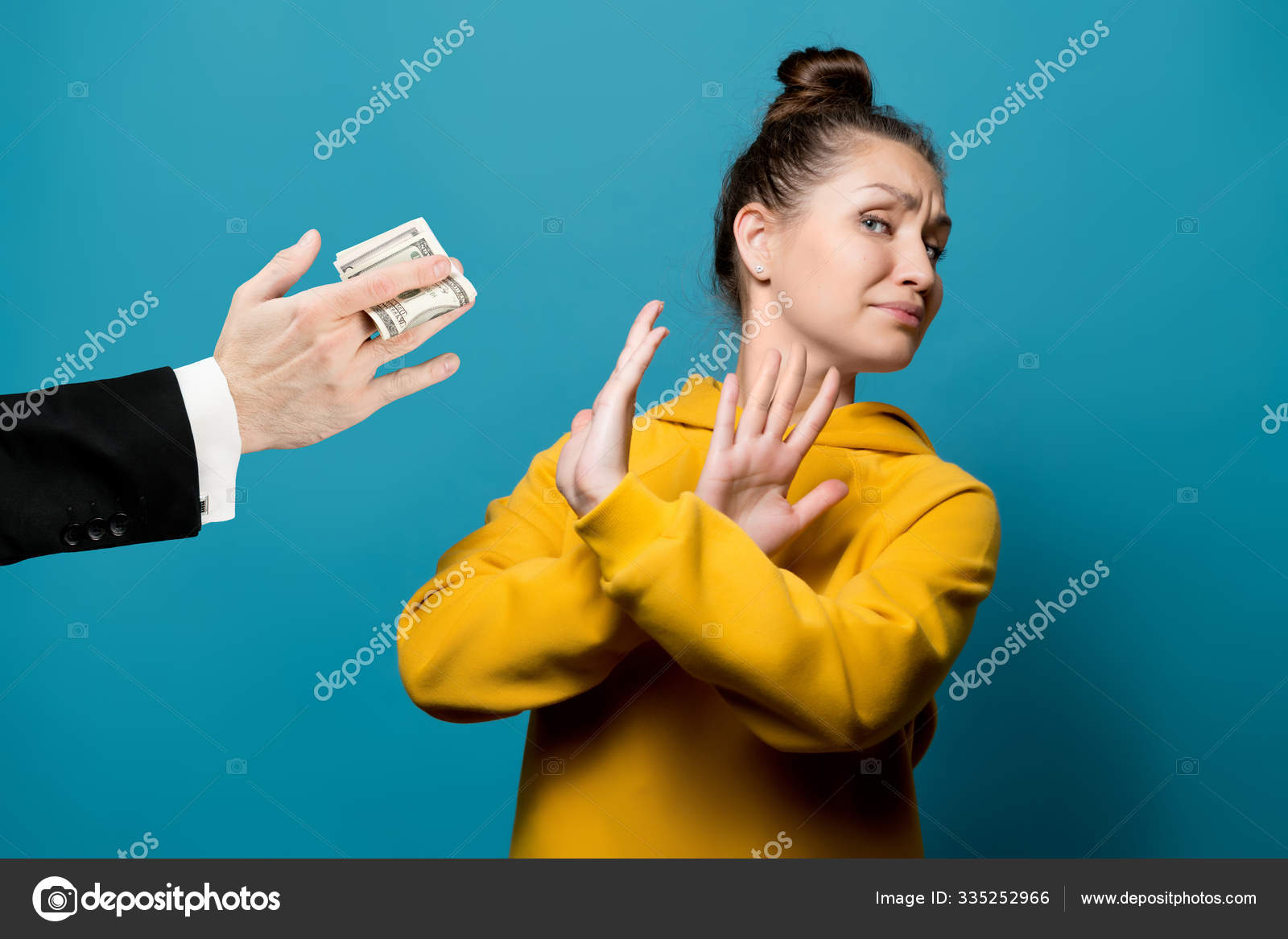 Girl refuses money, which a male in jacket hand holds out to her ...