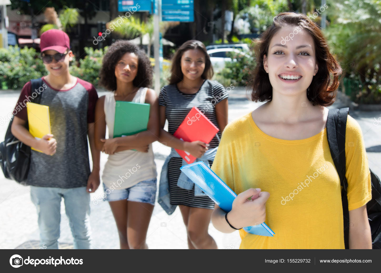 Beautiful caucasian female student with group of international s ...