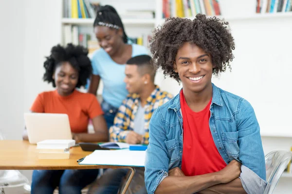 Young african american computer science student with group of students ...