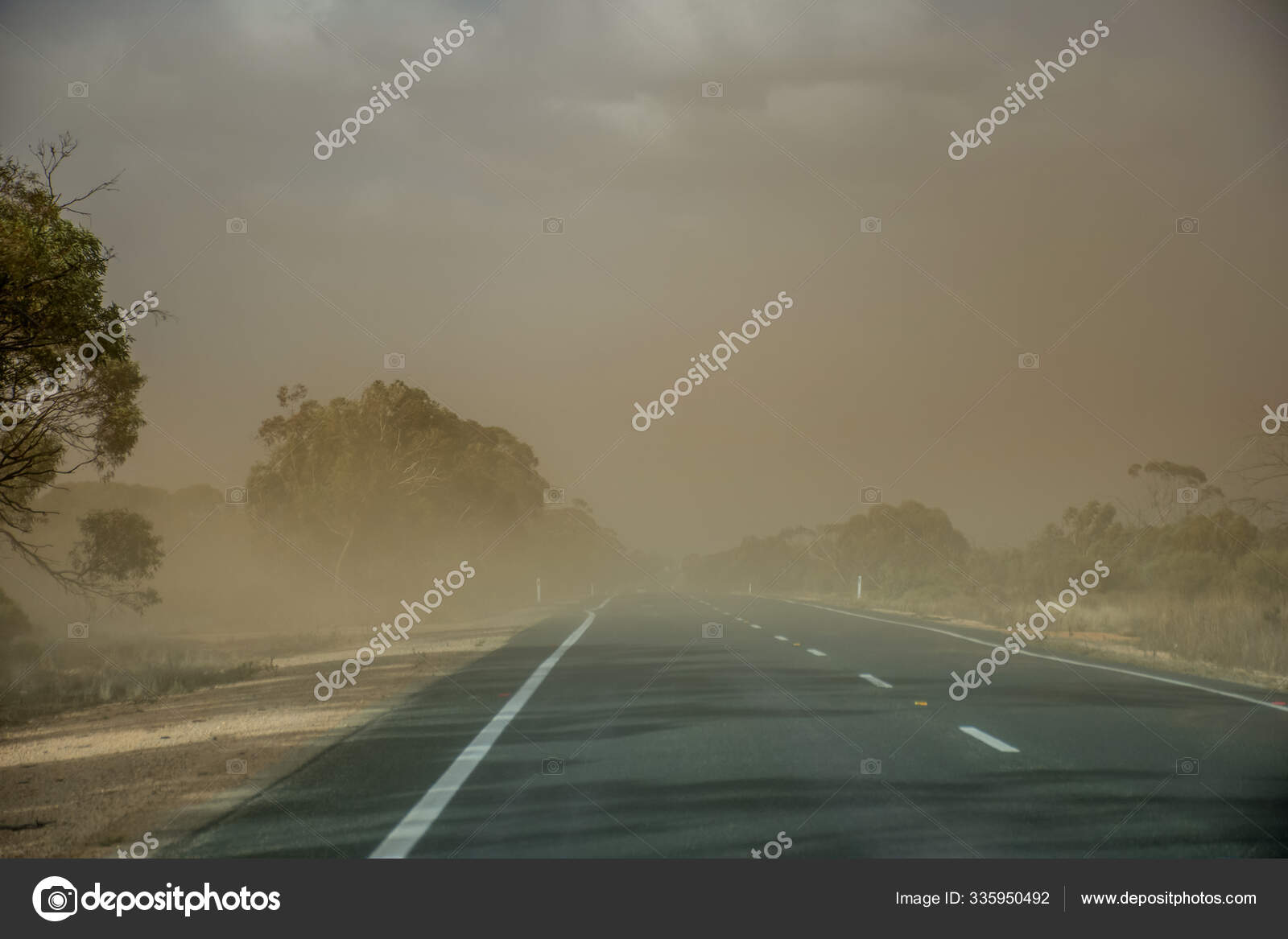 A dust storm on the road near Mildura, Australia. Dust particles in the ...
