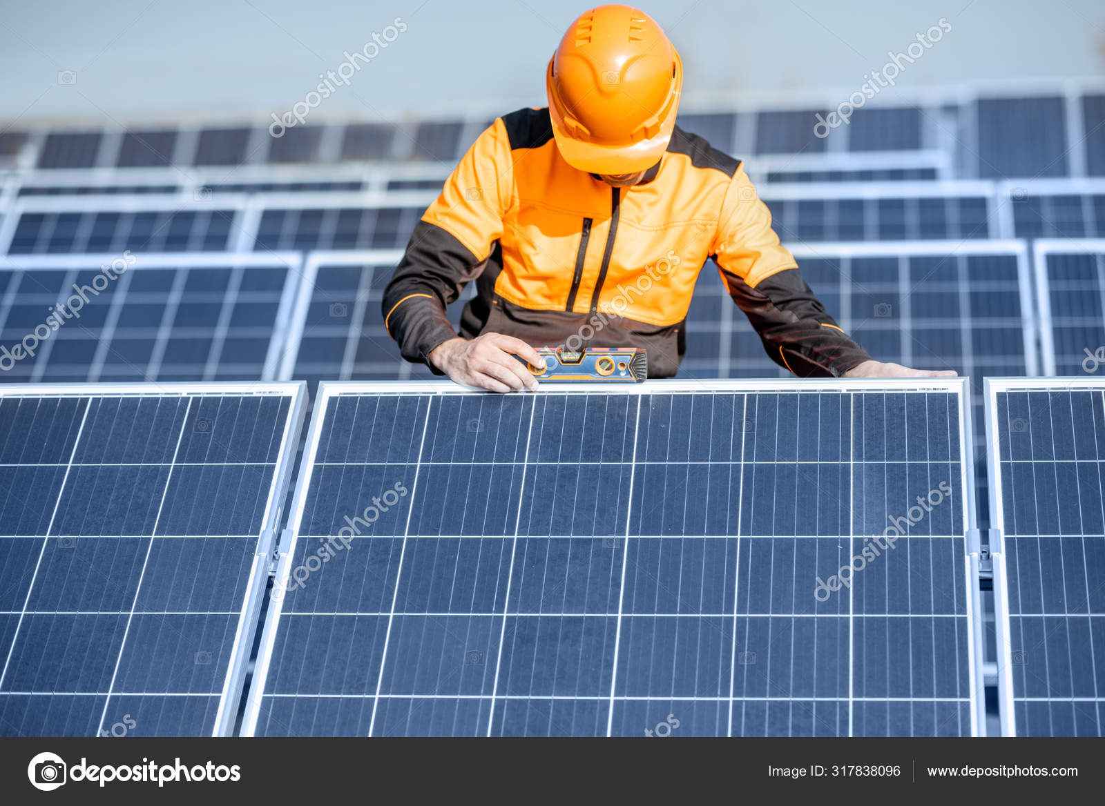 Workman on the solar station Stock Photo by ©rossandhelen 317838096