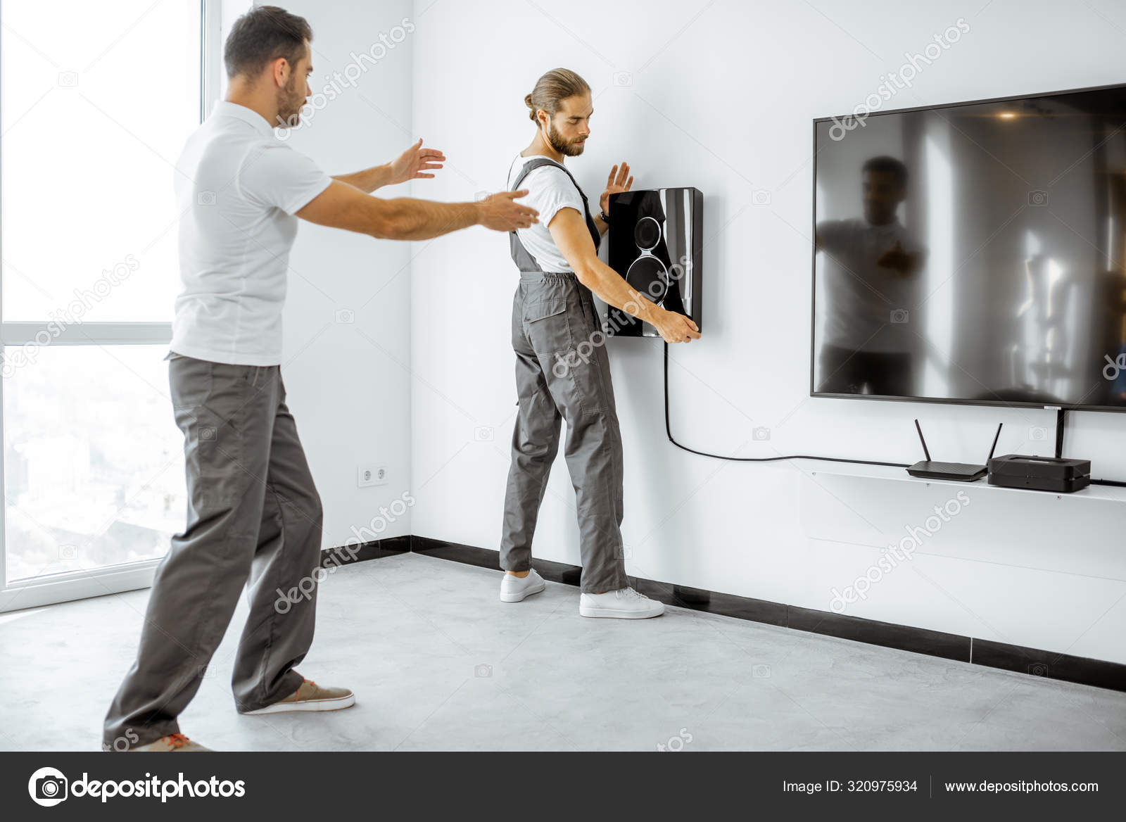 Workmen installing audio system at home Stock Photo by ©rossandhelen ...