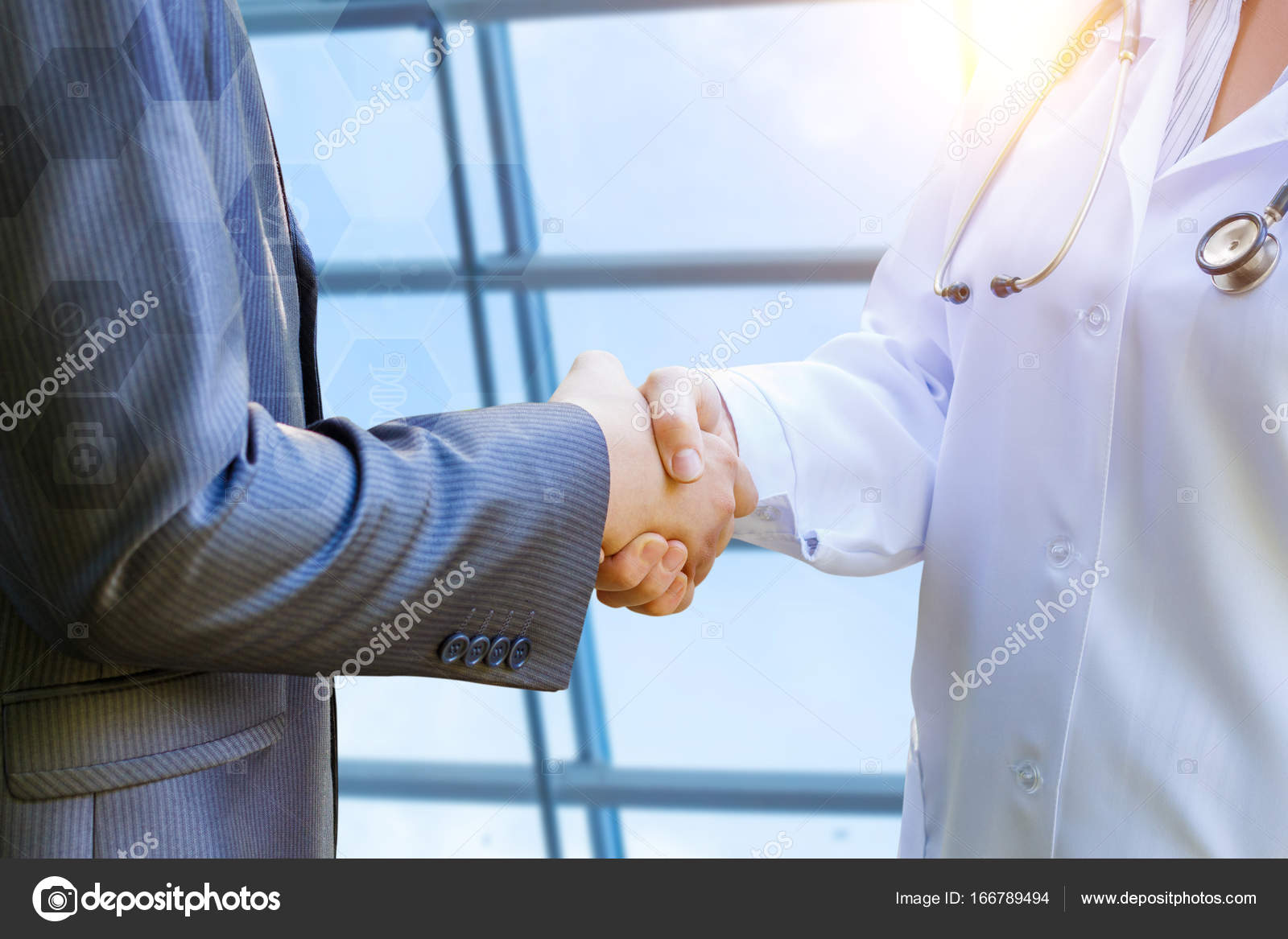 Doctor shakes hands with patient . Stock Photo by ©NataliMis 166789494