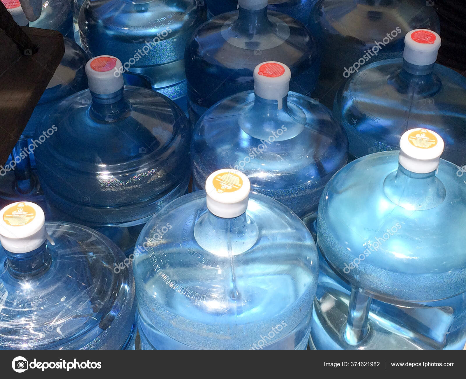 Five 5 gallon water bottles full and empty blue plastic dry and ...