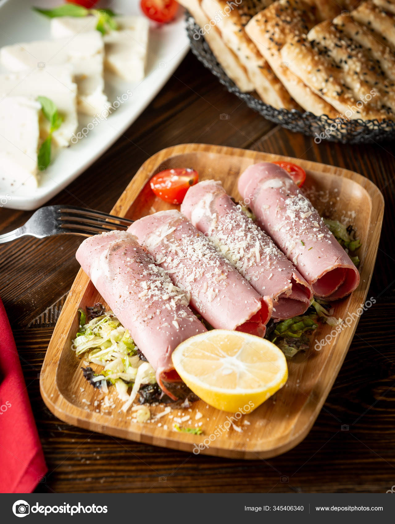 Ham wrapped in a roll and sprinkled with grated parmesan — Stock Photo ...