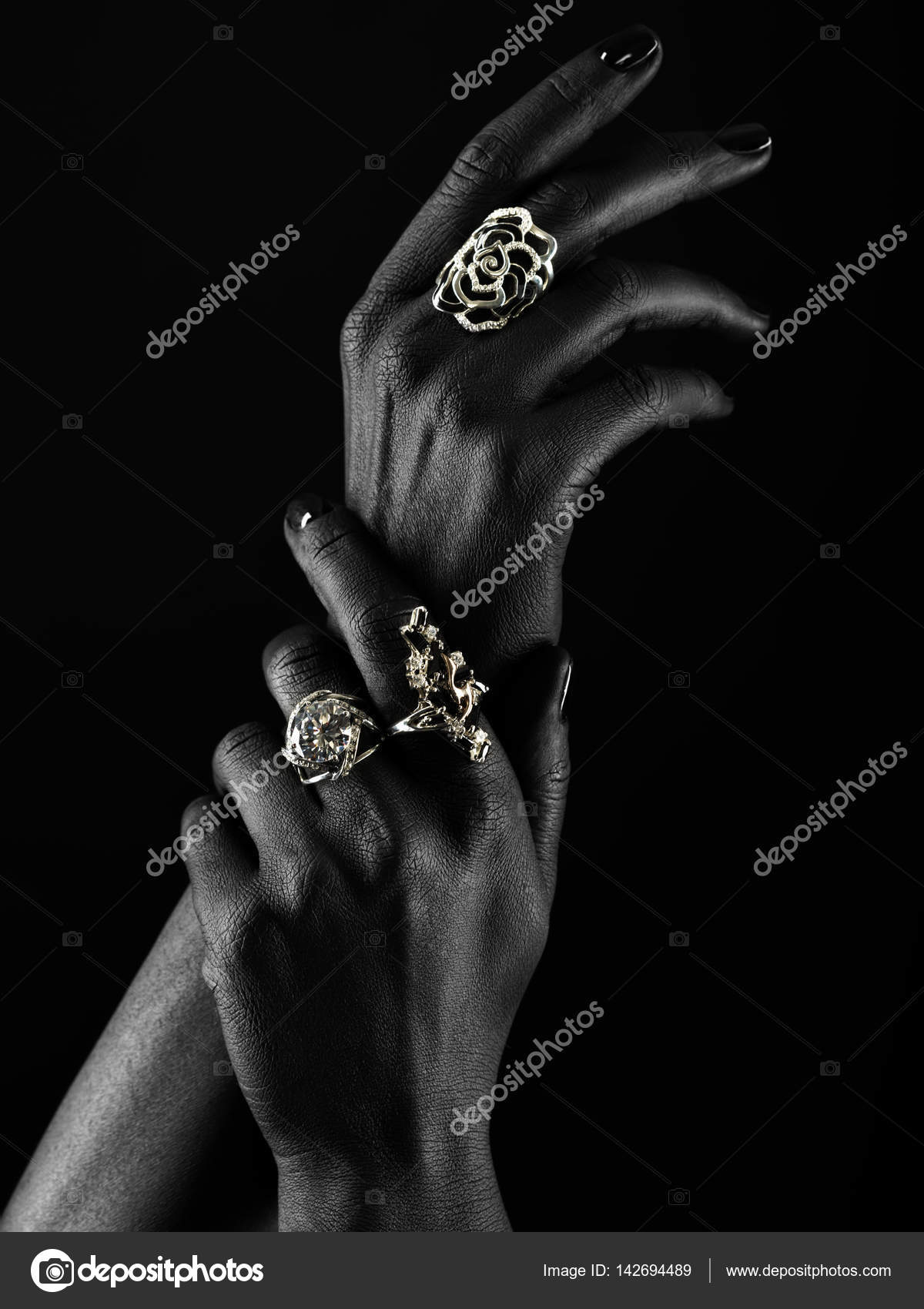Dark-skinned hand with jewelry on a black background ⬇ Stock Photo ...
