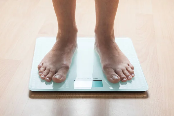 Legs on the scales. Checking the weight. Losing weight. - Stock Image ...