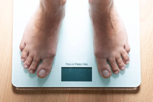 Legs on the scales. Checking the weight. Losing weight. - Stock Image ...