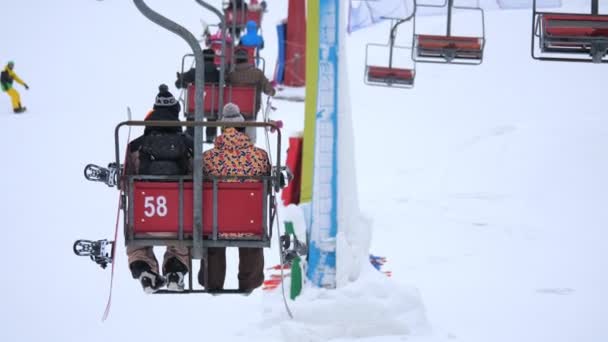 Skiers riding ropeway on mountain slope — Stock Video © sonicbox #355640336