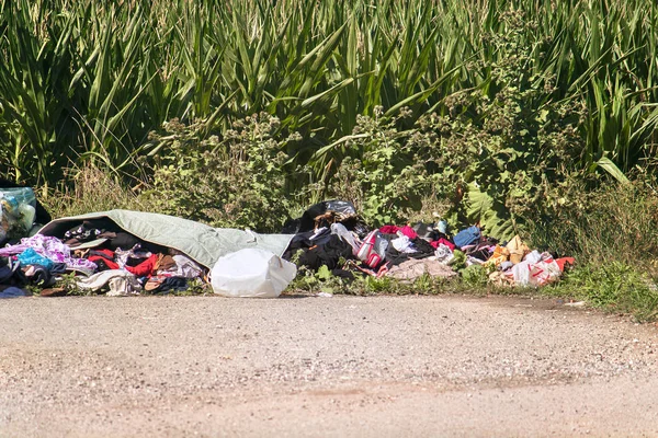 waste of clothes of second hand, some old stuff on the grass as junk ...