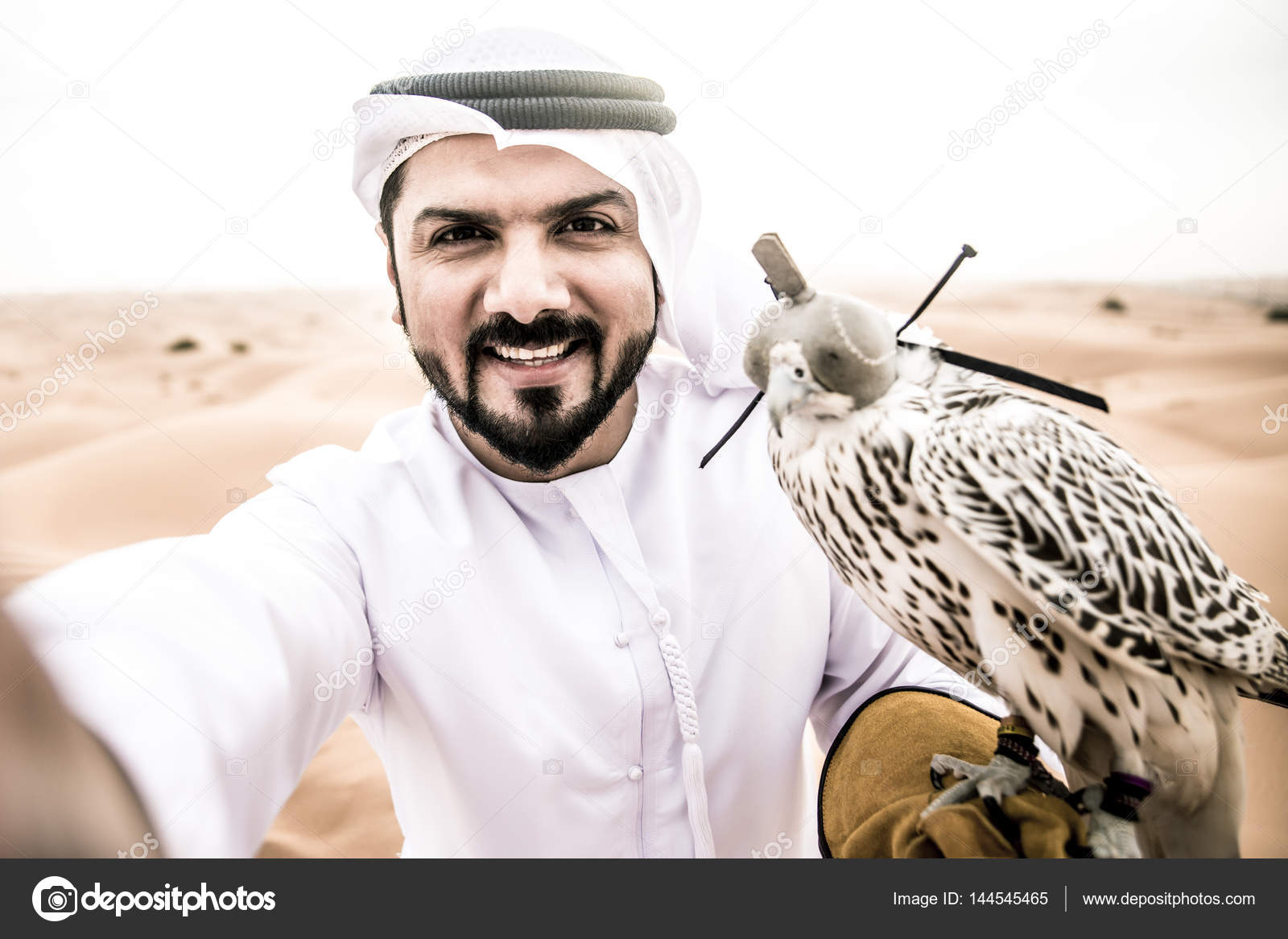 Arabic man with falcon bird Stock Photo by ©oneinchpunch 144545465
