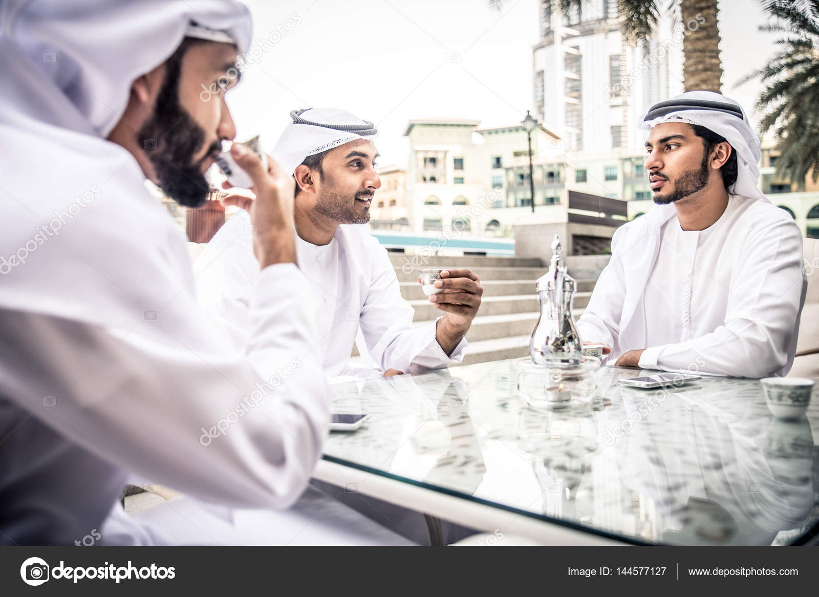 Arabian men meeting in restaurant — Stock Photo © oneinchpunch #144577127