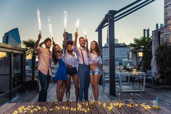 Friends partying on a rooftop - Stock Image - Everypixel