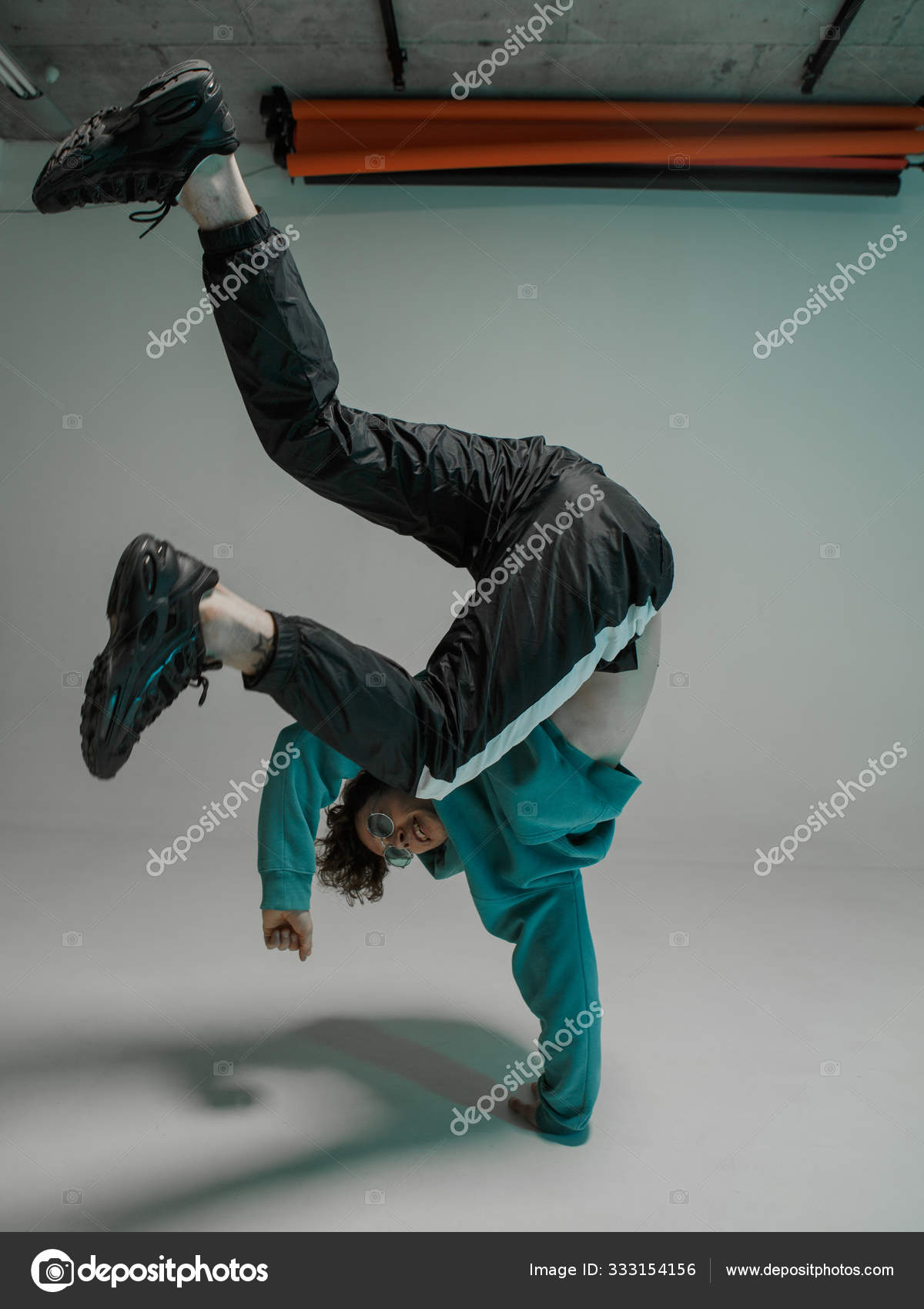 Boy dancing contemporary dance in studio. Acrobatic dancer. Stock Photo ...