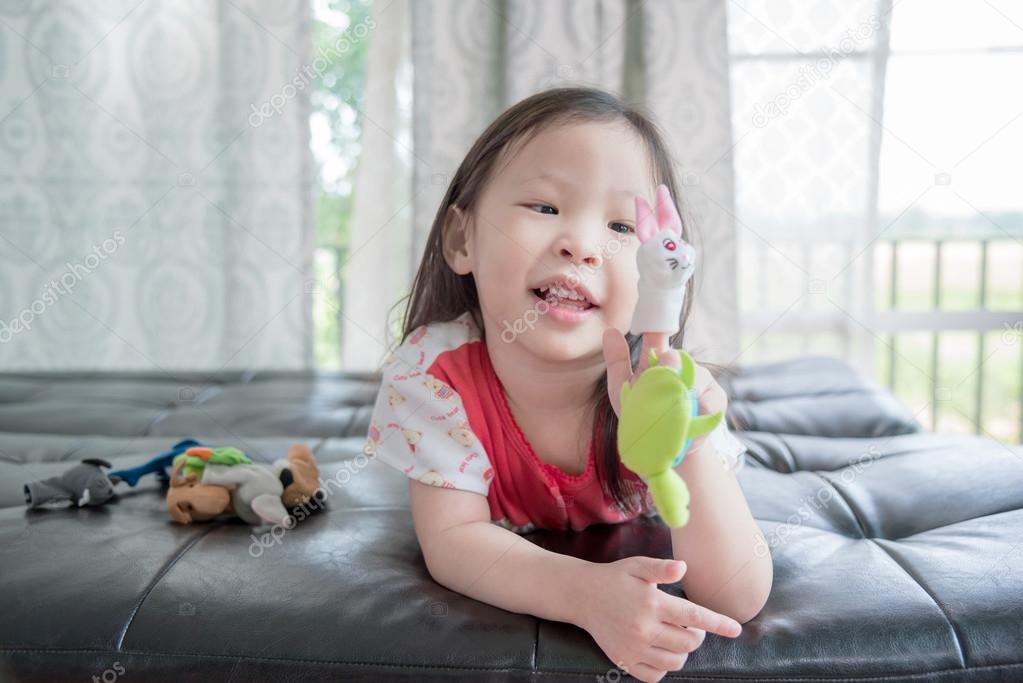 Girl playing with animal puppets Stock Photo by ©parinyabinsuk 128667848