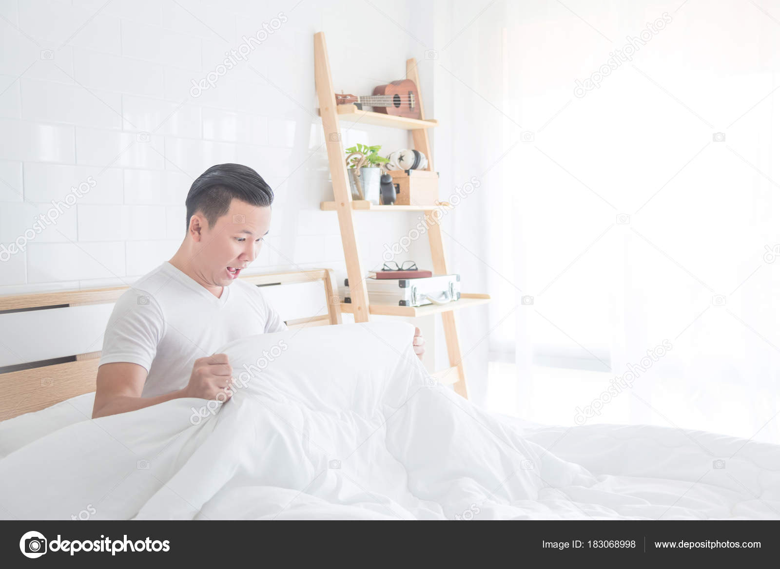 Man looking under blanket with excited face — Stock Photo ...